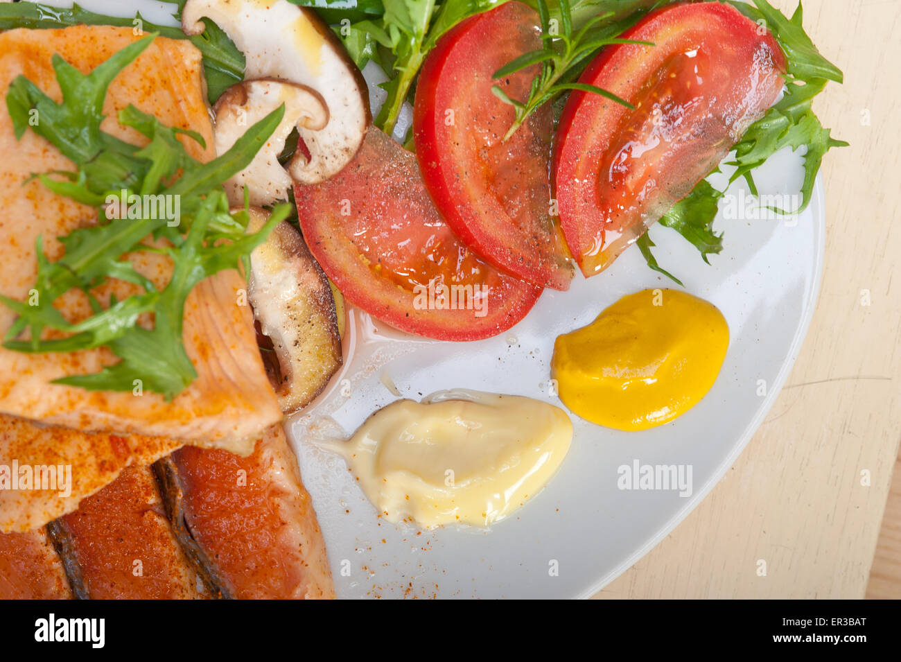 grilled fresh samon filet with vegetables salad tomato arugula ...