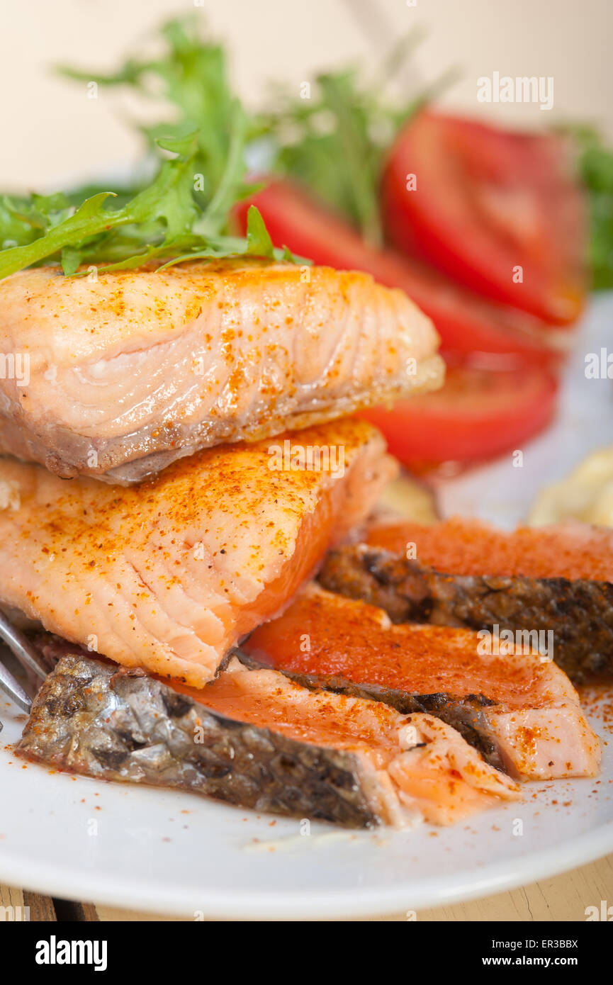 grilled fresh samon filet with vegetables salad tomato arugula ...