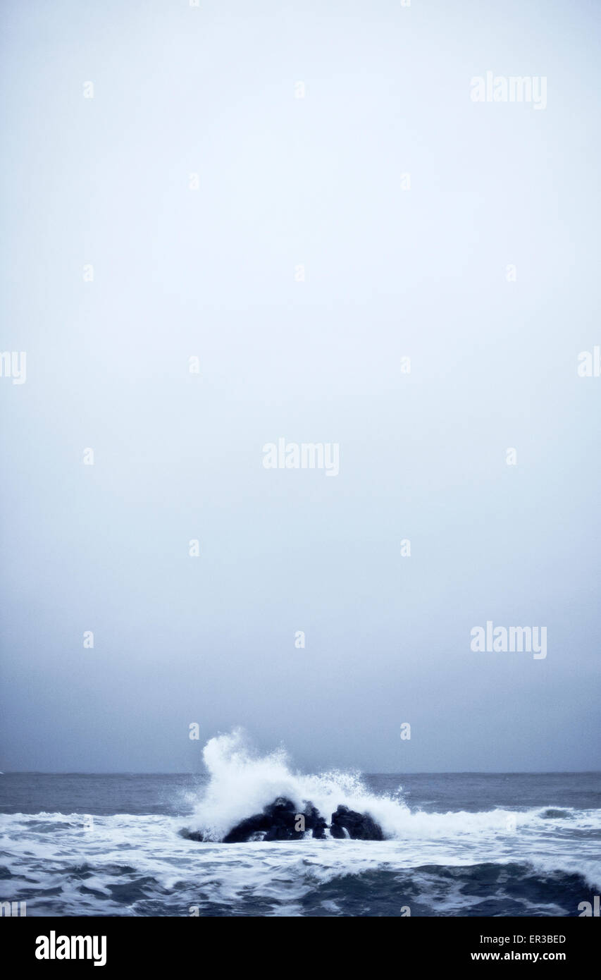 Waves crashing against rocks Stock Photo - Alamy