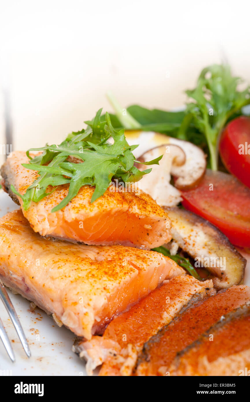 grilled fresh samon filet with vegetables salad tomato arugula ...