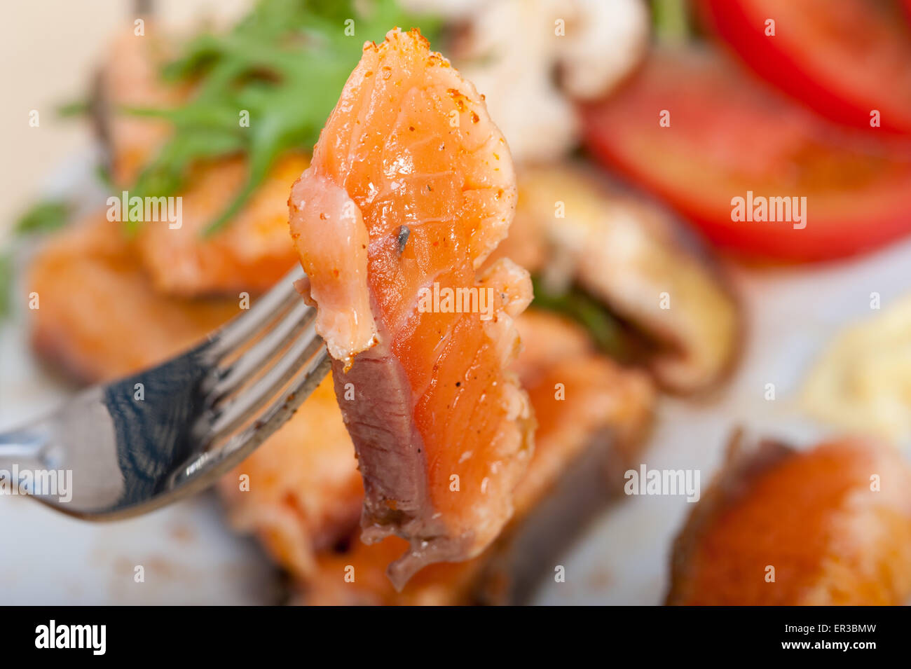 grilled fresh samon filet with vegetables salad tomato arugula ...