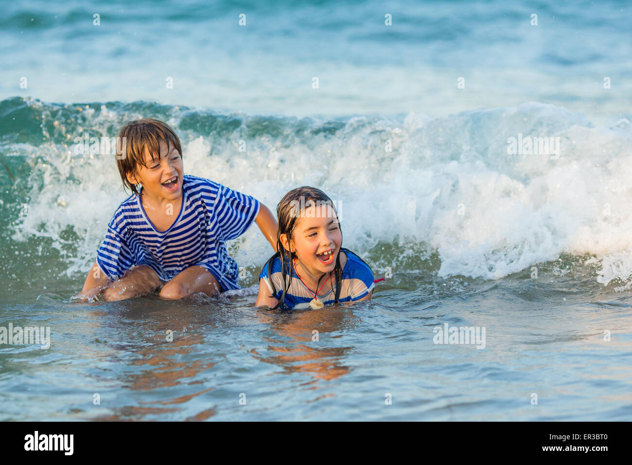 Two children playing in the sea Stock Photo: 83053712 - Alamy