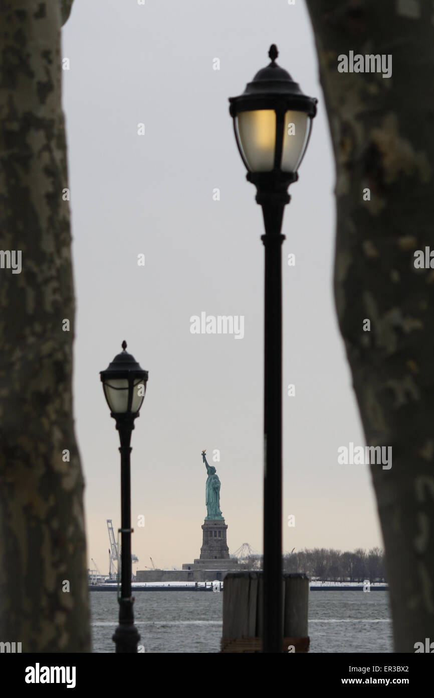 Statue of the Liberty seen through street lamps, New York, USA Stock ...