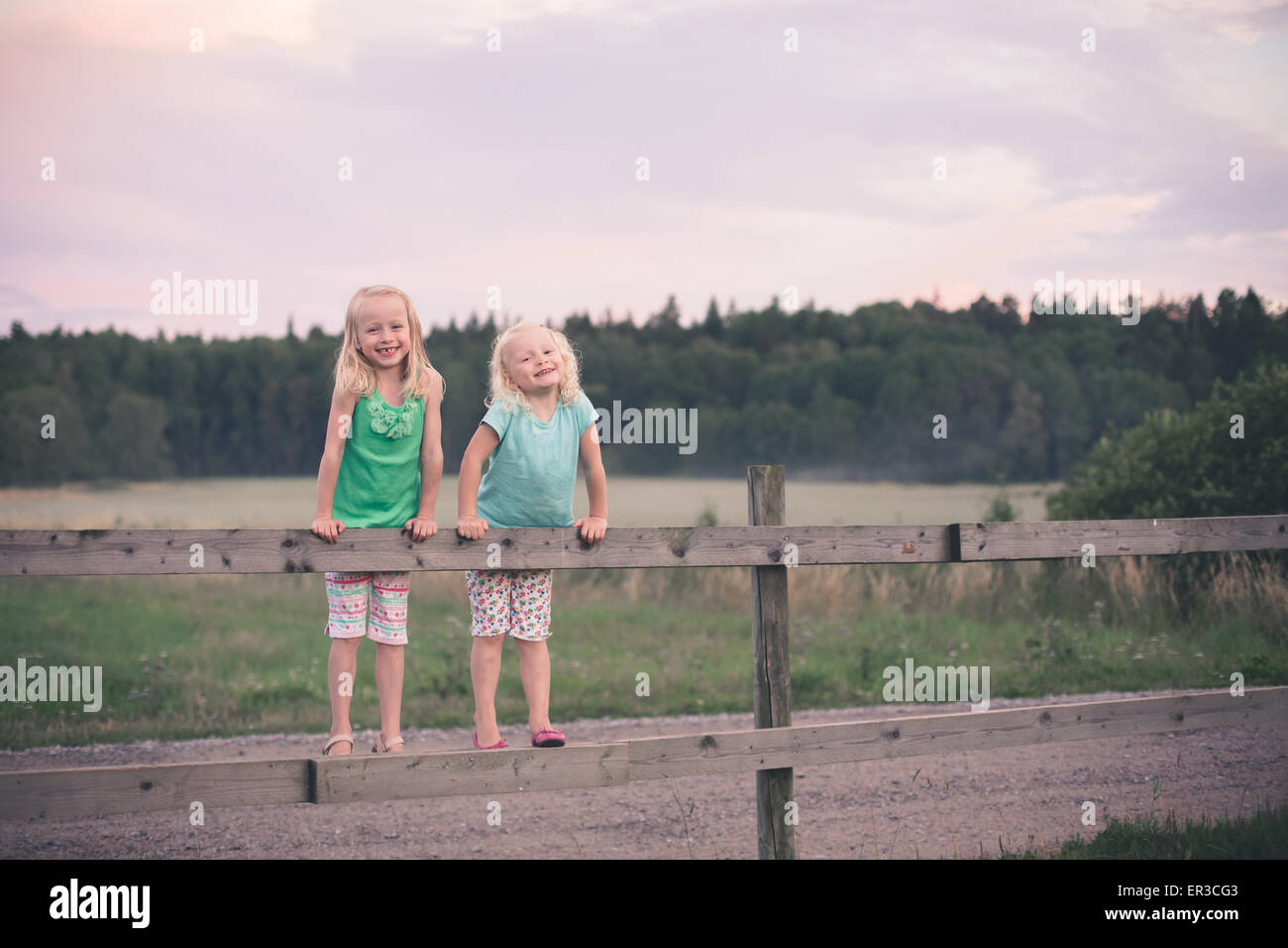 Two girls playing by a tree hi-res stock photography and images - Alamy