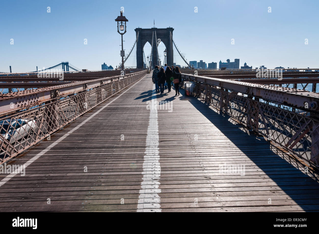 People cross the Brooklyn bridge in backlight in New York City Stock ...