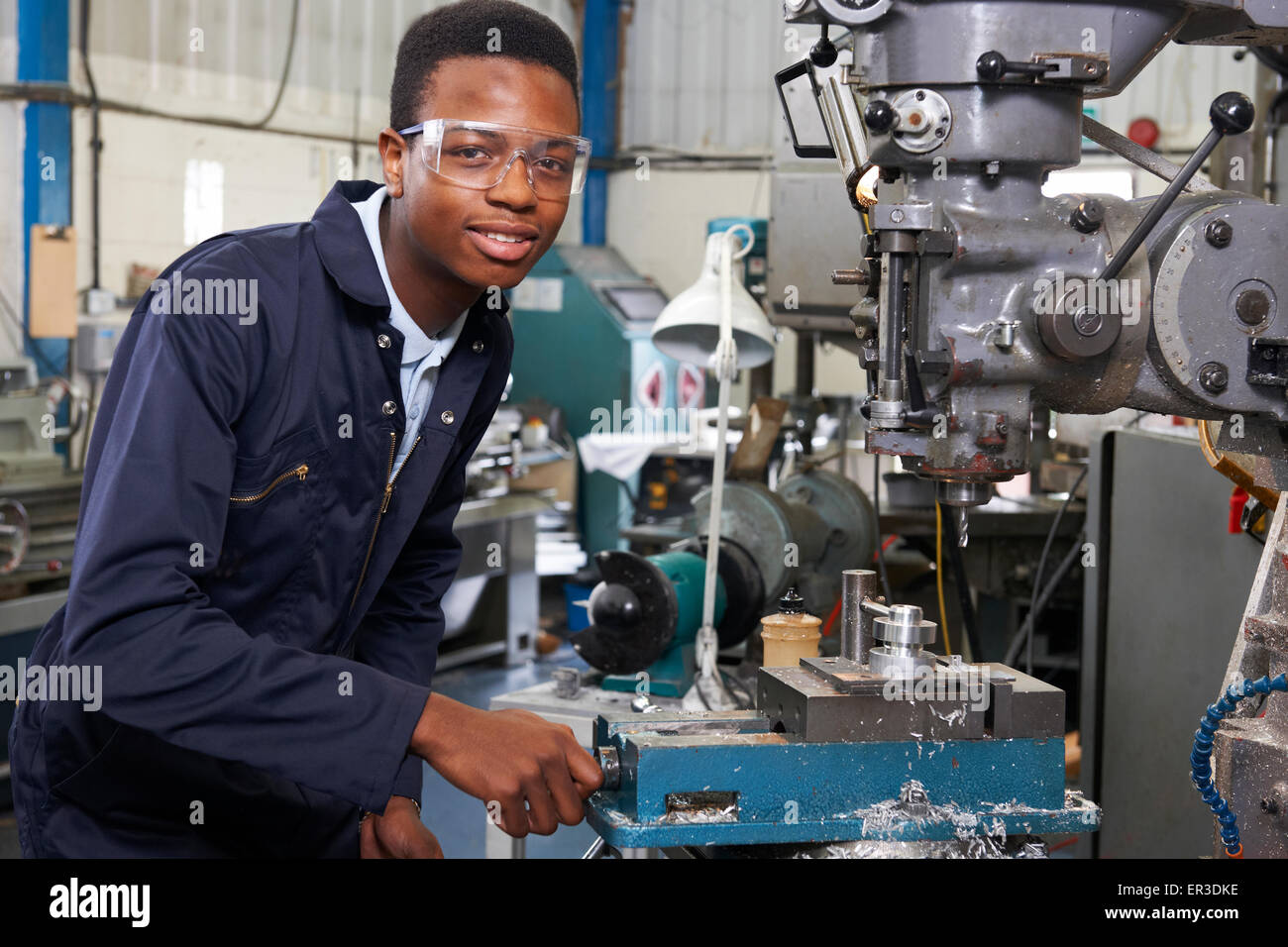 Male Apprentice Engineer Working On Drill In Factory Stock Photo - Alamy