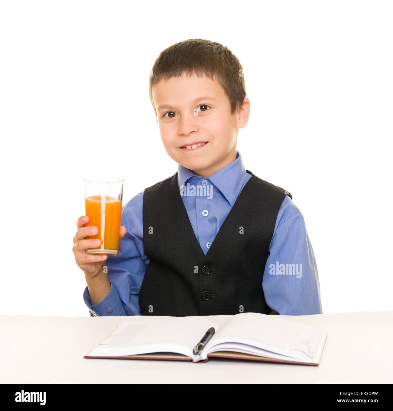 schoolboy drinks juice at a desk with diary and pen Stock Photo - Alamy
