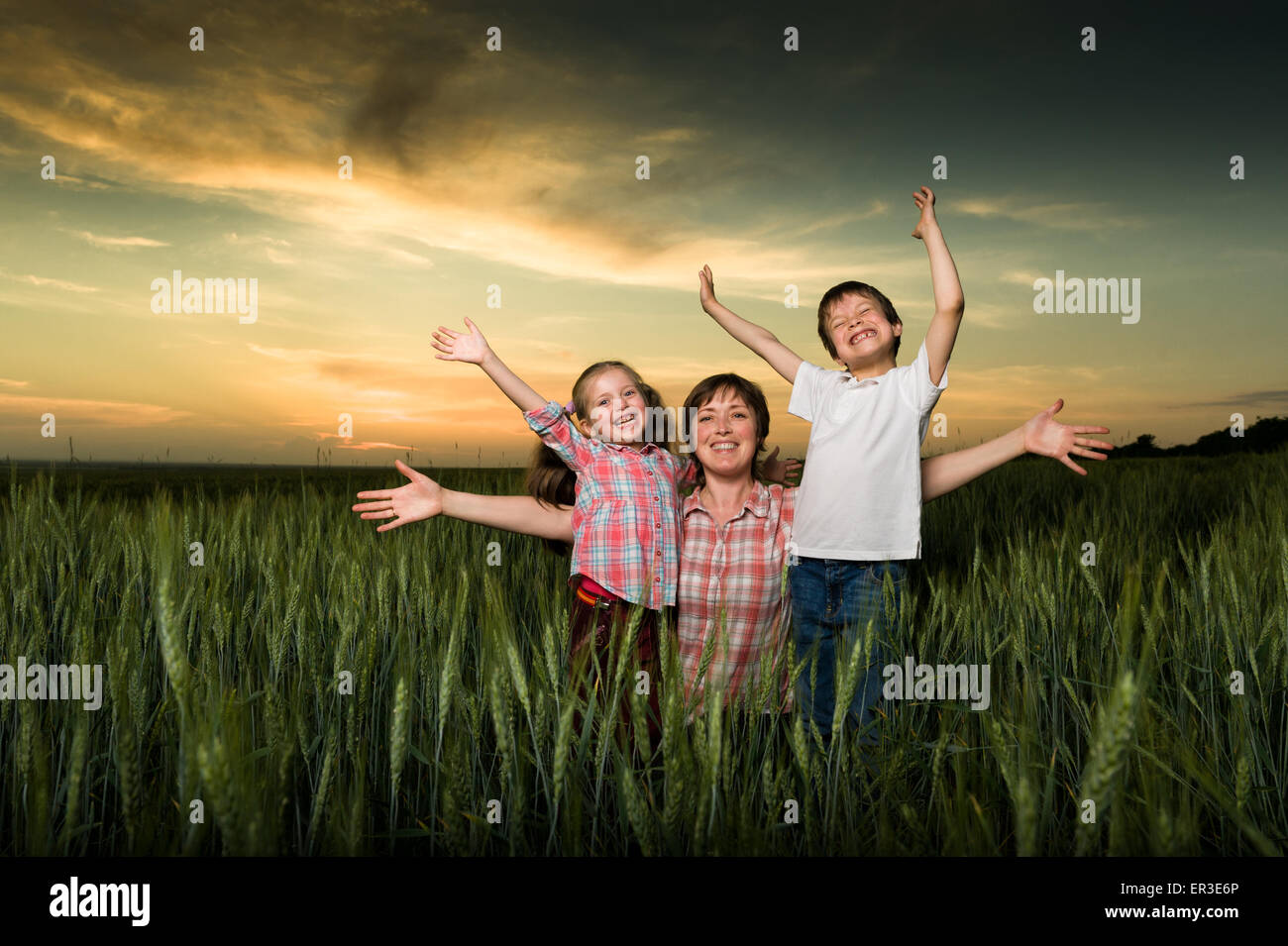 happy family at sunset Stock Photo - Alamy