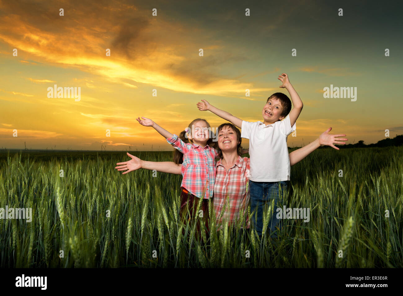 happy family at sunset Stock Photo - Alamy