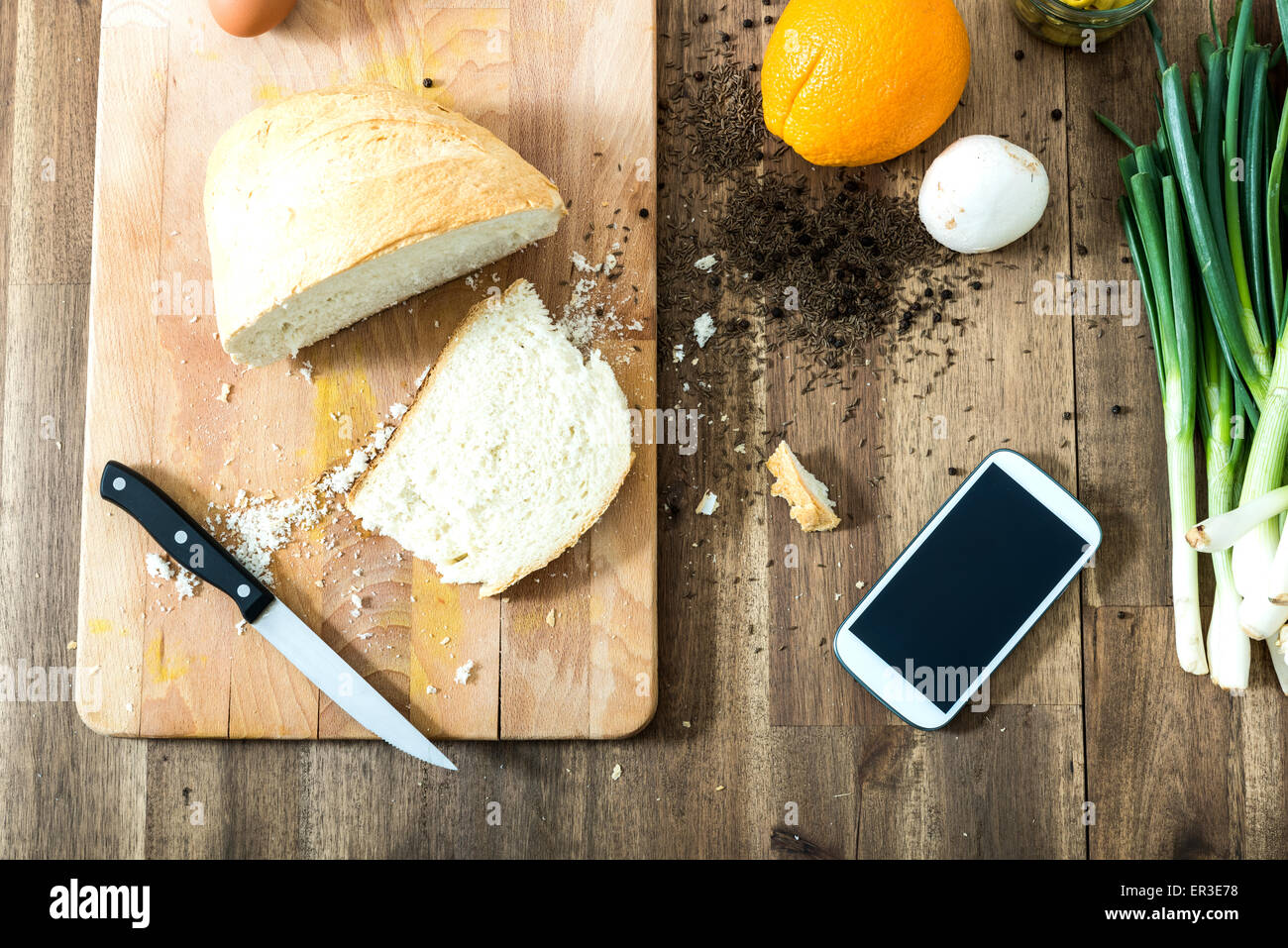 Retro picture of a smartphone lying in a natural kitchen with white ...