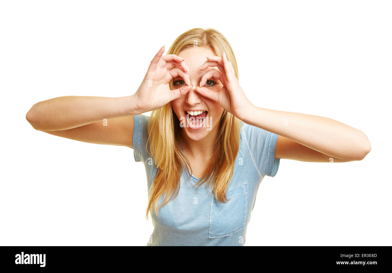 Young happy woman looking with her eyes through her fingers Stock Photo ...