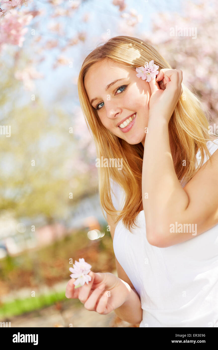 Blonde young woman with cherry blossoms in her hair in spring Stock ...