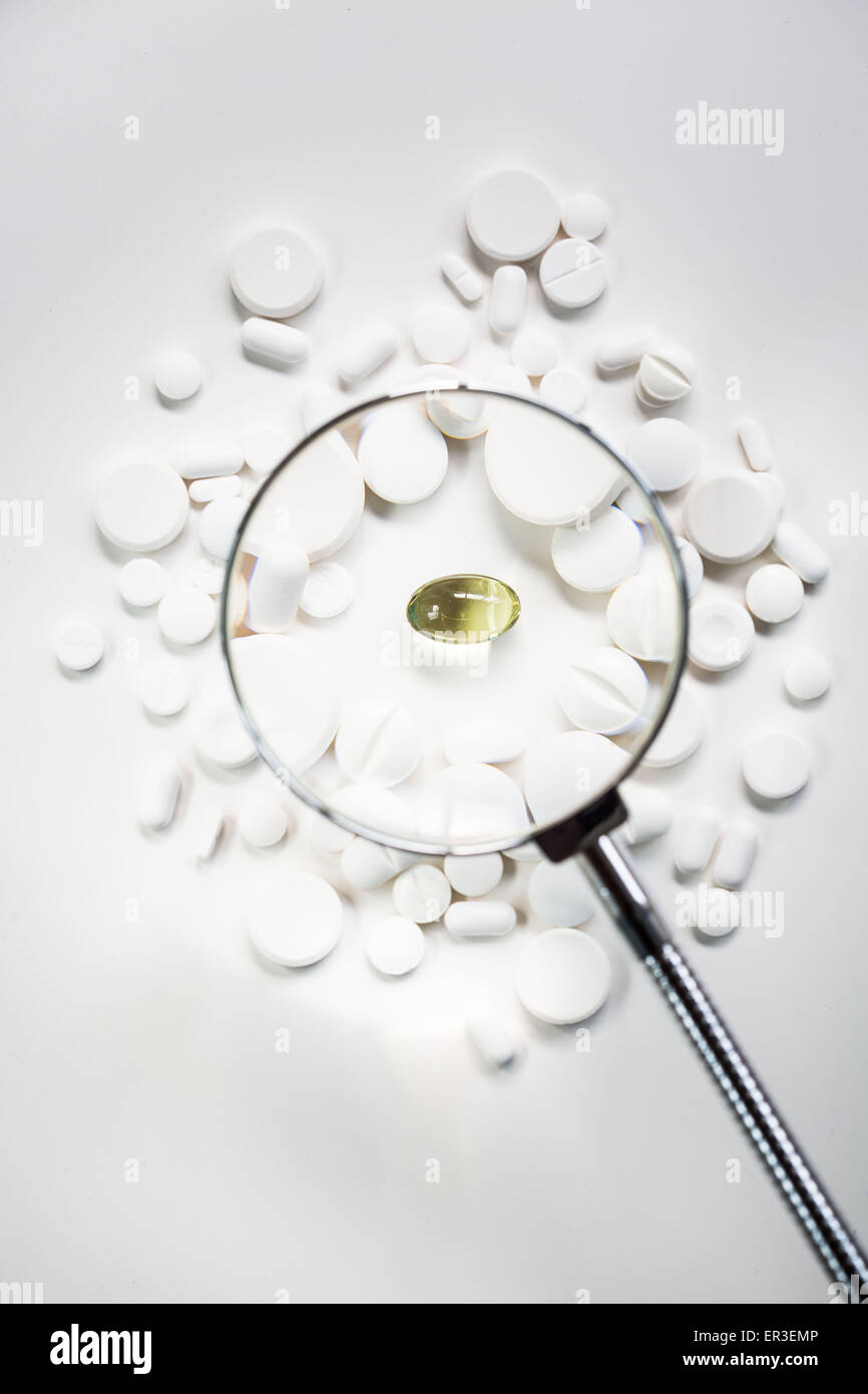 Medicine and magnifying glass Stock Photo - Alamy