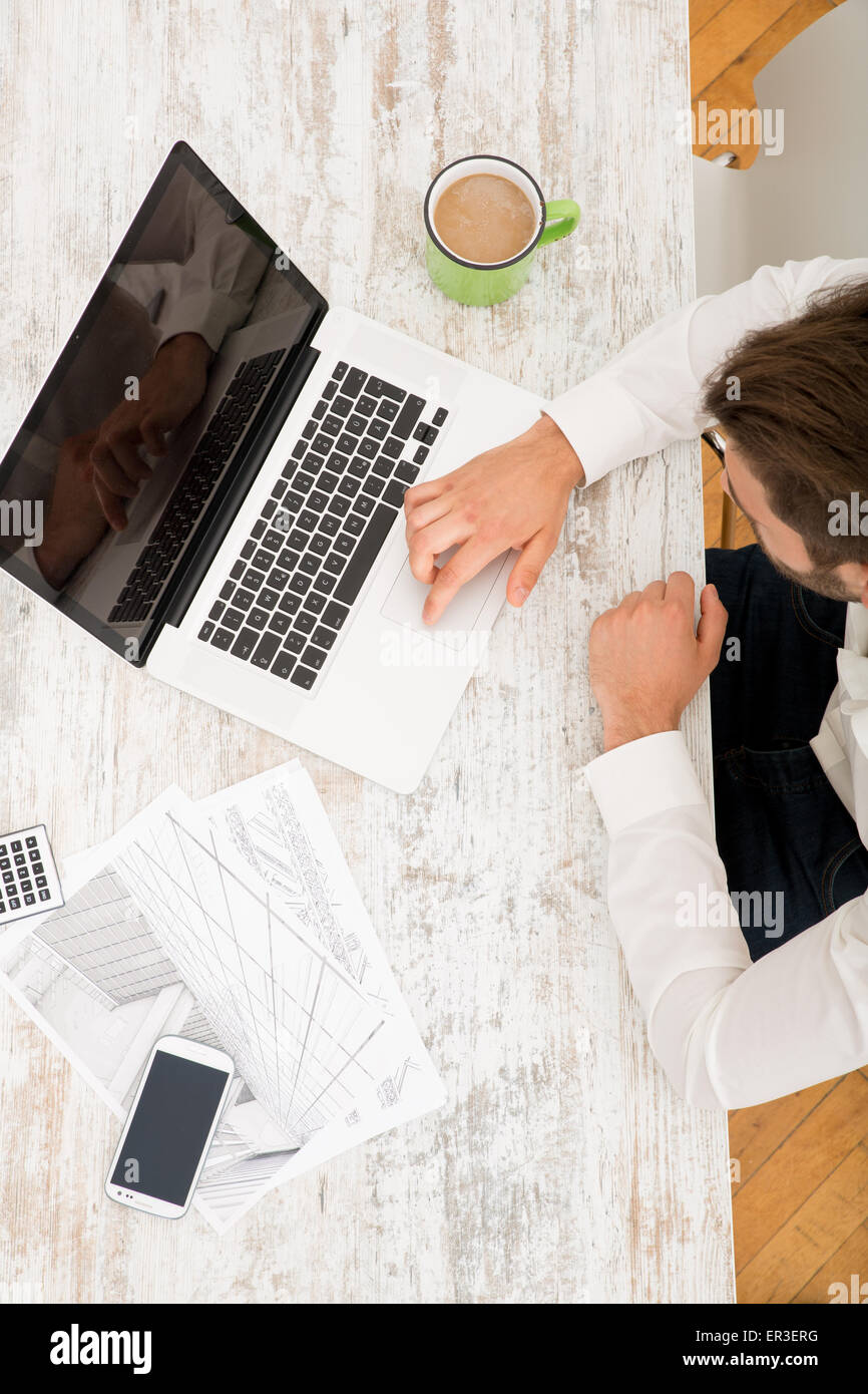 A young man working at home with a Laptop computer Stock Photo - Alamy