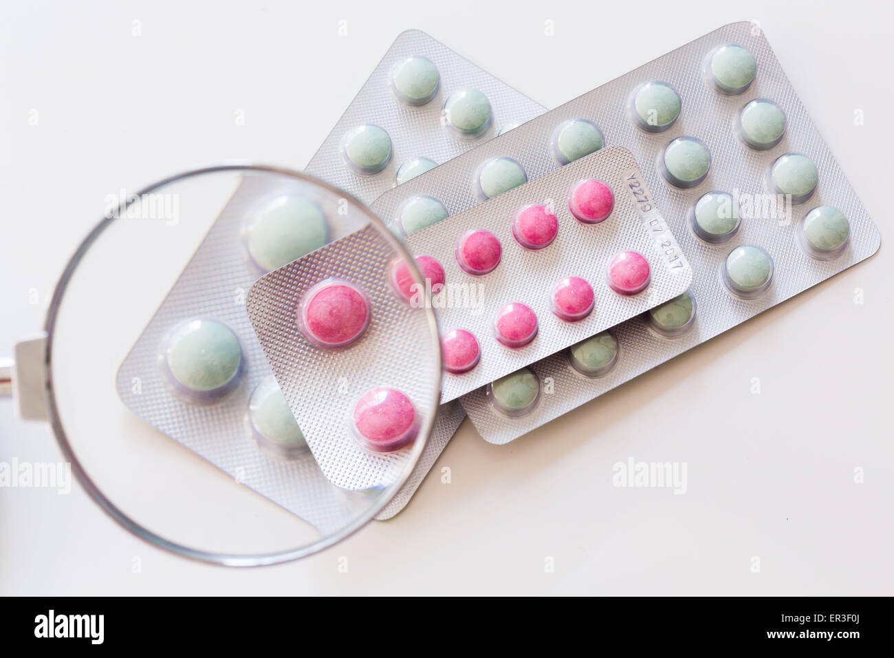 Medicine and magnifying glass Stock Photo - Alamy