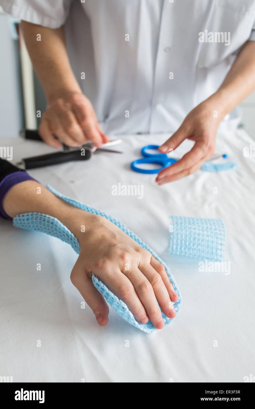 Patient with rheumatoid arthritis and physiotherapist, Fabrication of ...