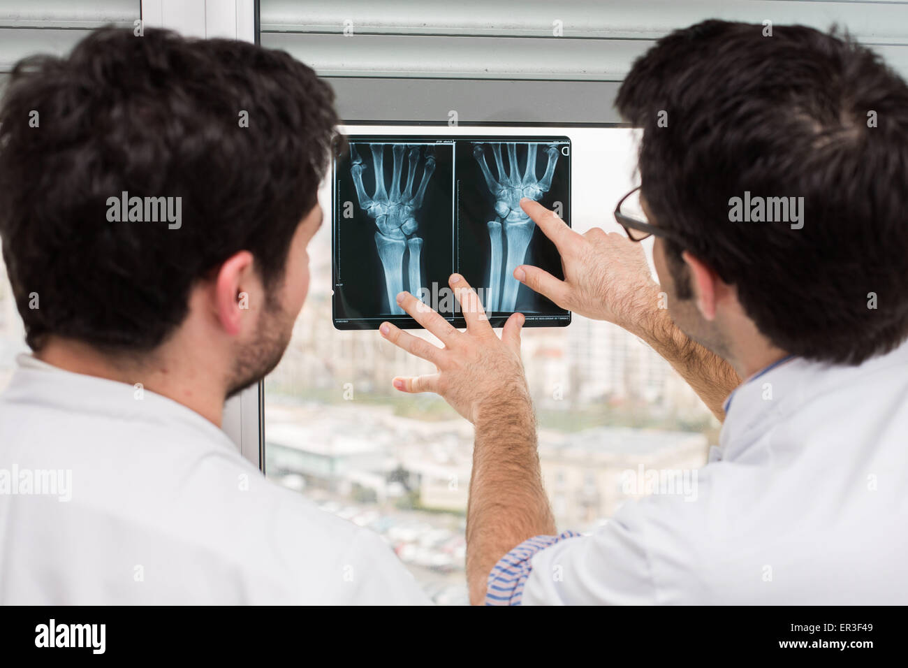 Rheumatologist Right And Internal Examining Radiographs Of The Hands
