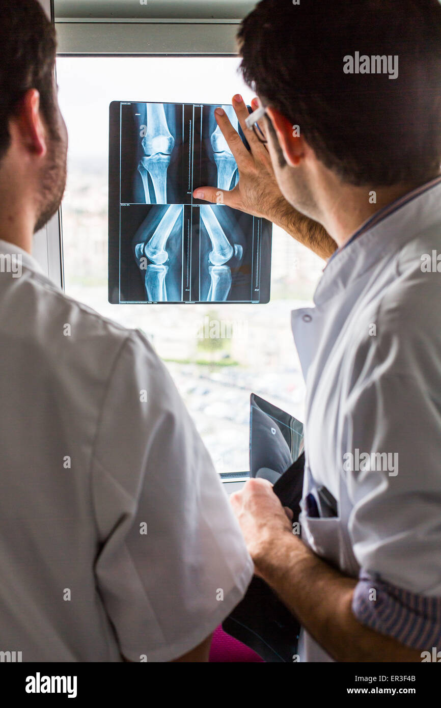Rheumatologist Right And Internal Examining Radiographs Of The Knee