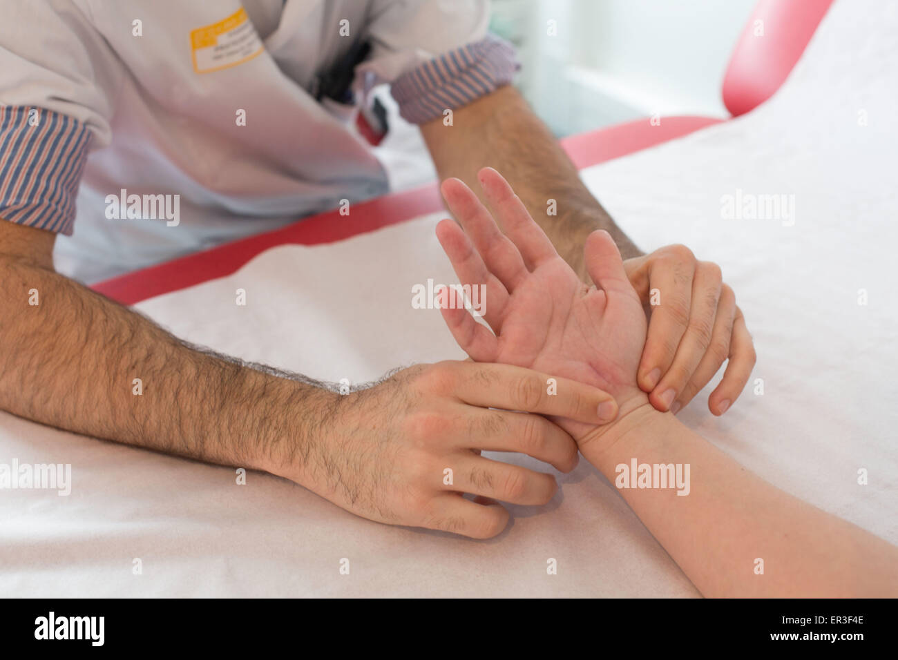 Rheumatologist examining the hand of a patient after surgery carpal ...