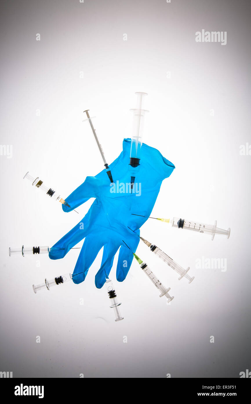 Glove and syringes. Conceptual image about the risk of contamination ...