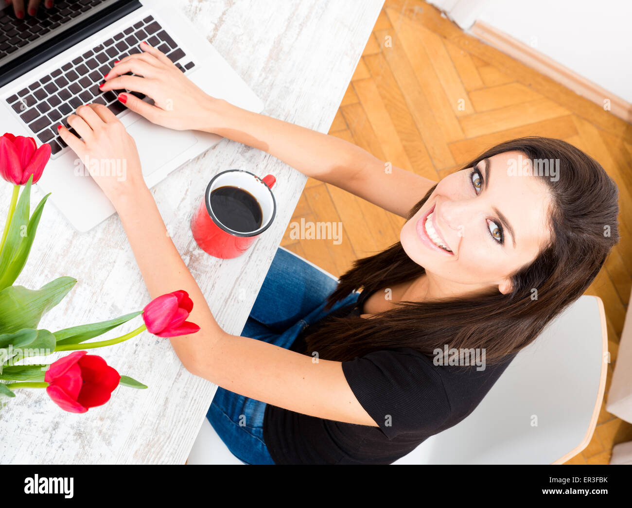 A young beautiful woman using a Laptop computer at home Stock Photo - Alamy