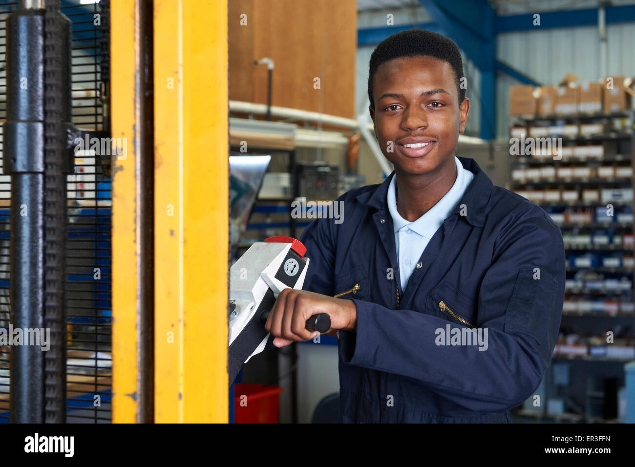 Factory Worker Using Powered Fork Lift To Load Goods Stock Photo - Alamy