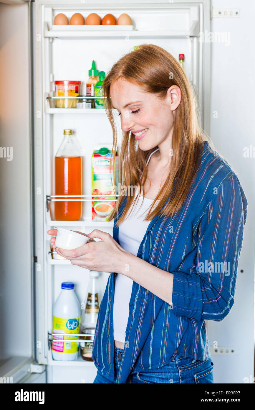 Woman checking label food fridge hi-res stock photography and images ...