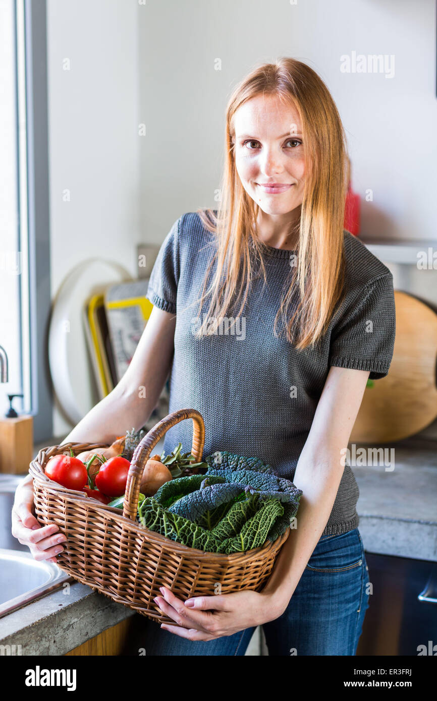 Woman with a basket of vegetables Stock Photo - Alamy