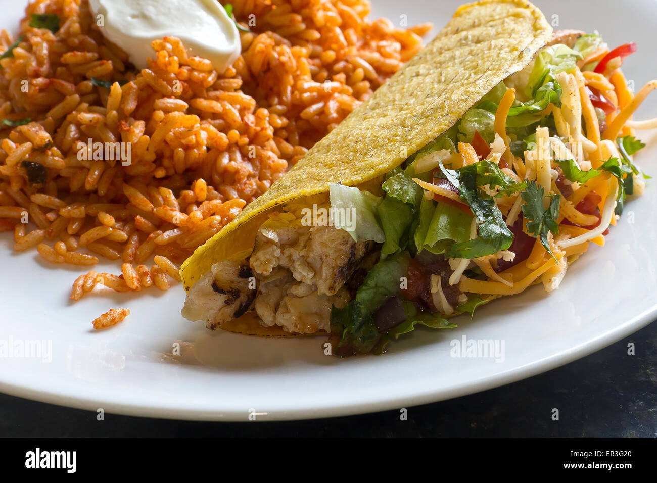 Chicken Hard Shell Taco with Mexican rice and sour cream Stock Photo ...
