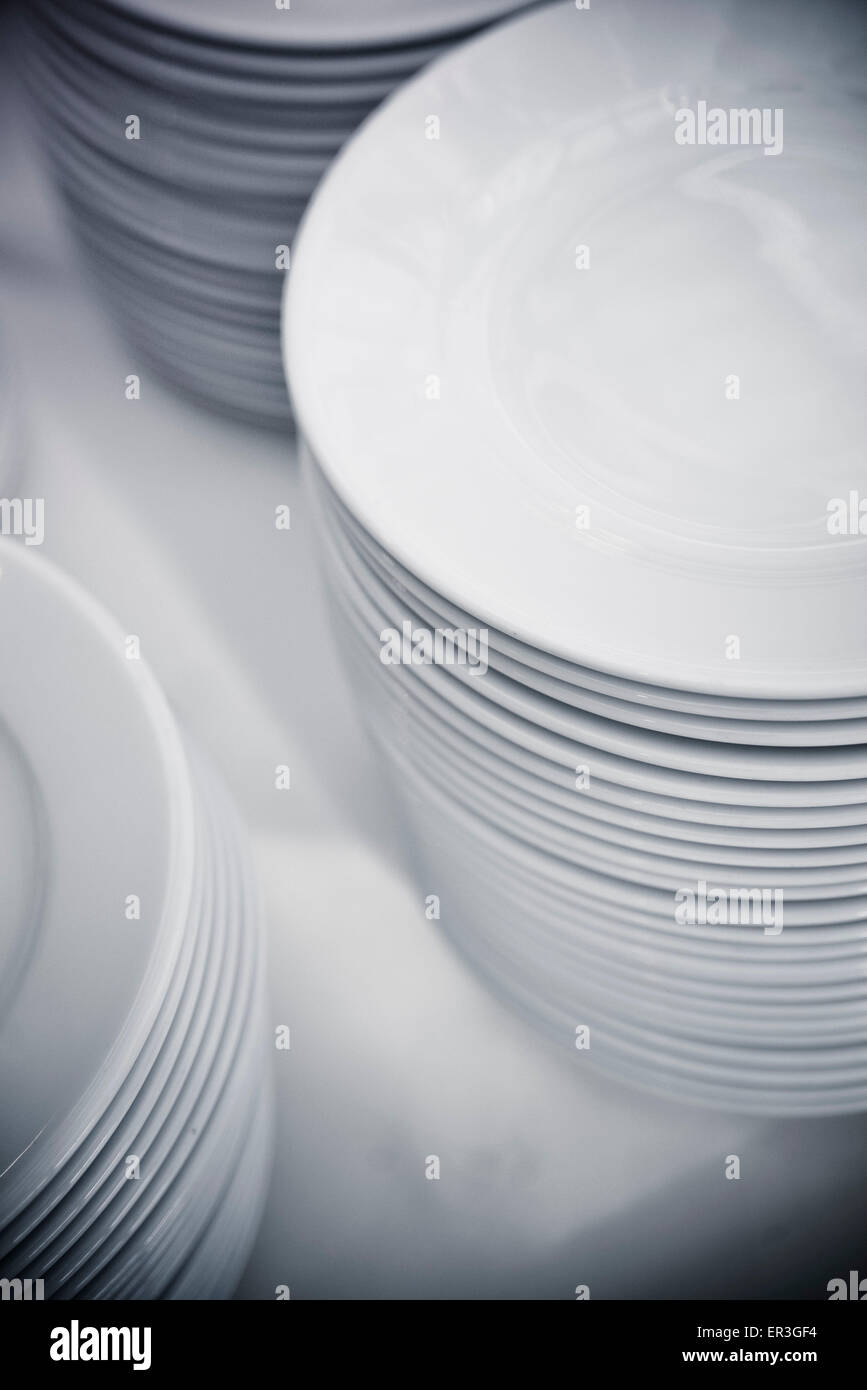 Plates stacked on table Stock Photo - Alamy