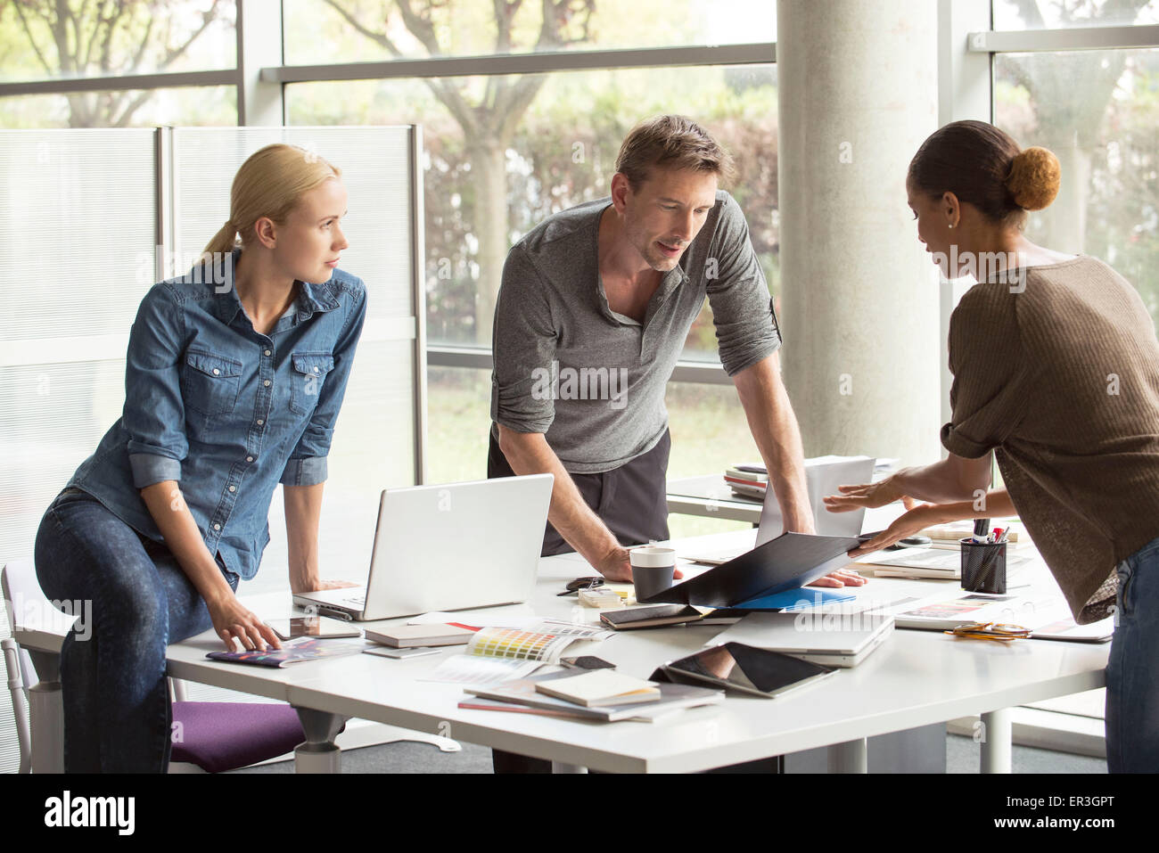 Colleagues collaborating on project Stock Photo - Alamy