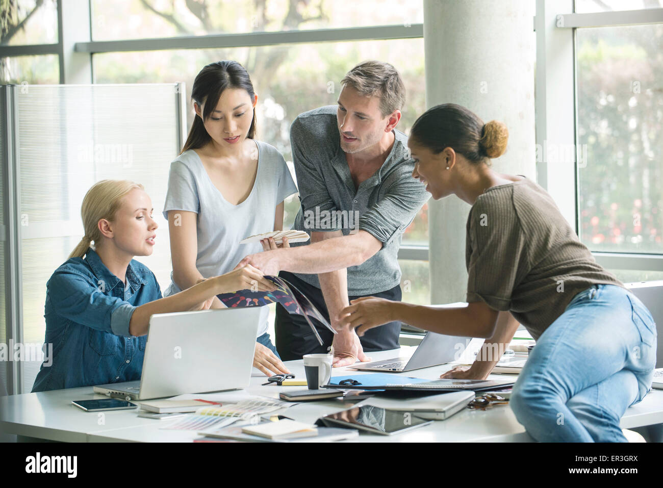 Colleagues working together on project Stock Photo - Alamy