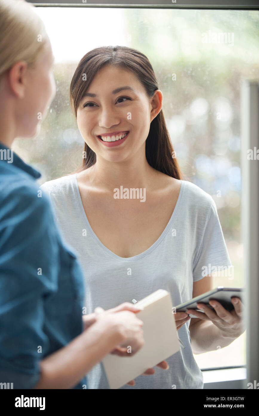 Woman chatting with friend, smiling Stock Photo - Alamy