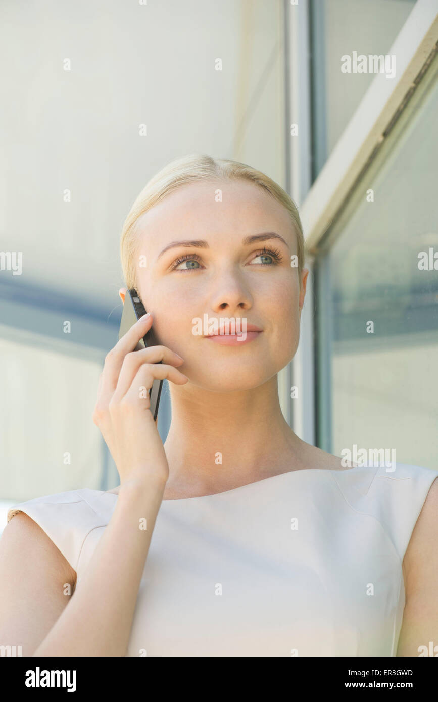Woman using cell phone, portrait Stock Photo - Alamy