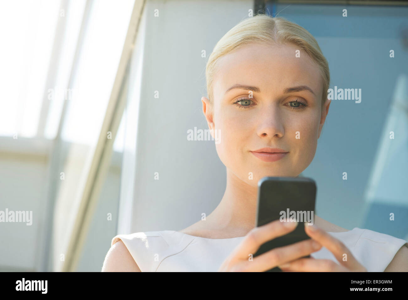 Woman using multimedia smartphone Stock Photo - Alamy