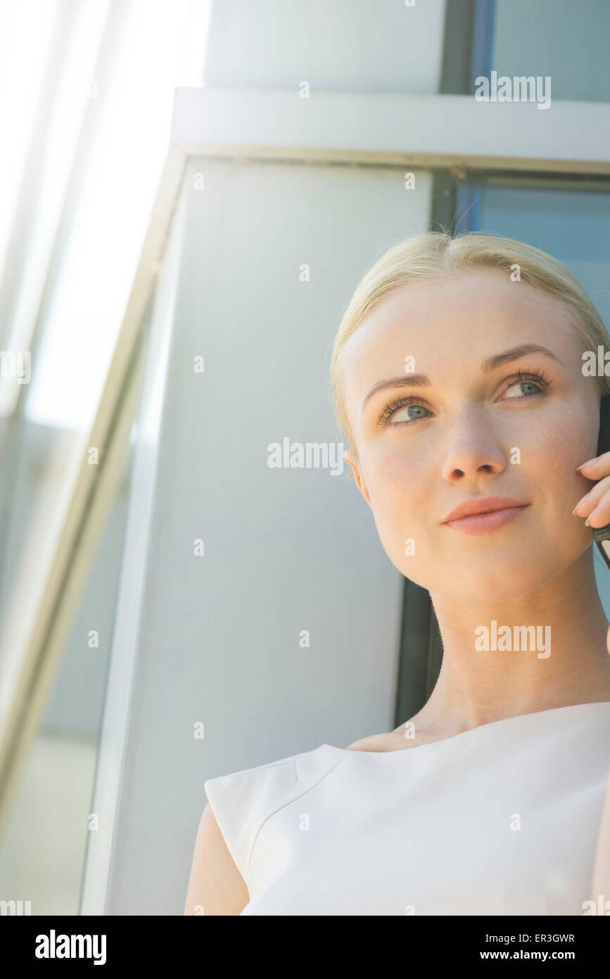 Woman using cell phone, smiling Stock Photo - Alamy