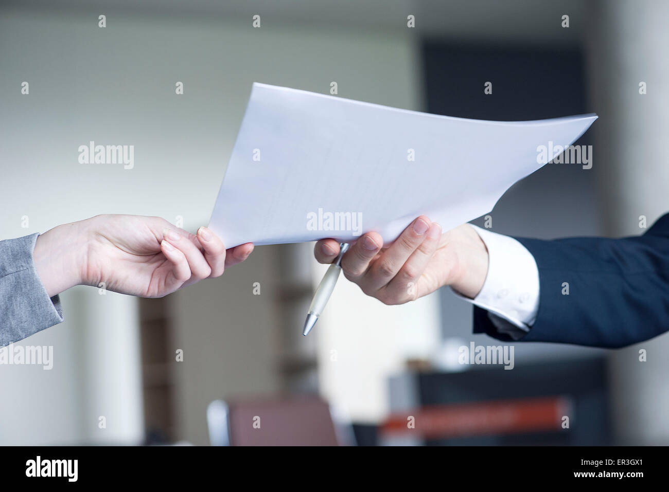 Businessman handing document to colleague, cropped Stock Photo - Alamy