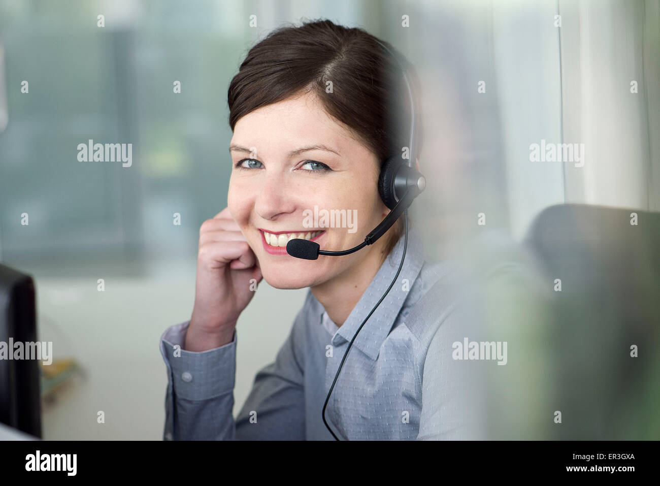 Businesswoman wearing headset during conference call, portrait Stock ...
