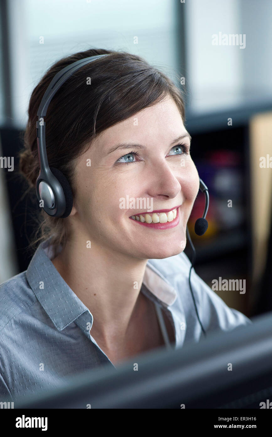 Receptionist smiling cheerfully, portrait Stock Photo - Alamy