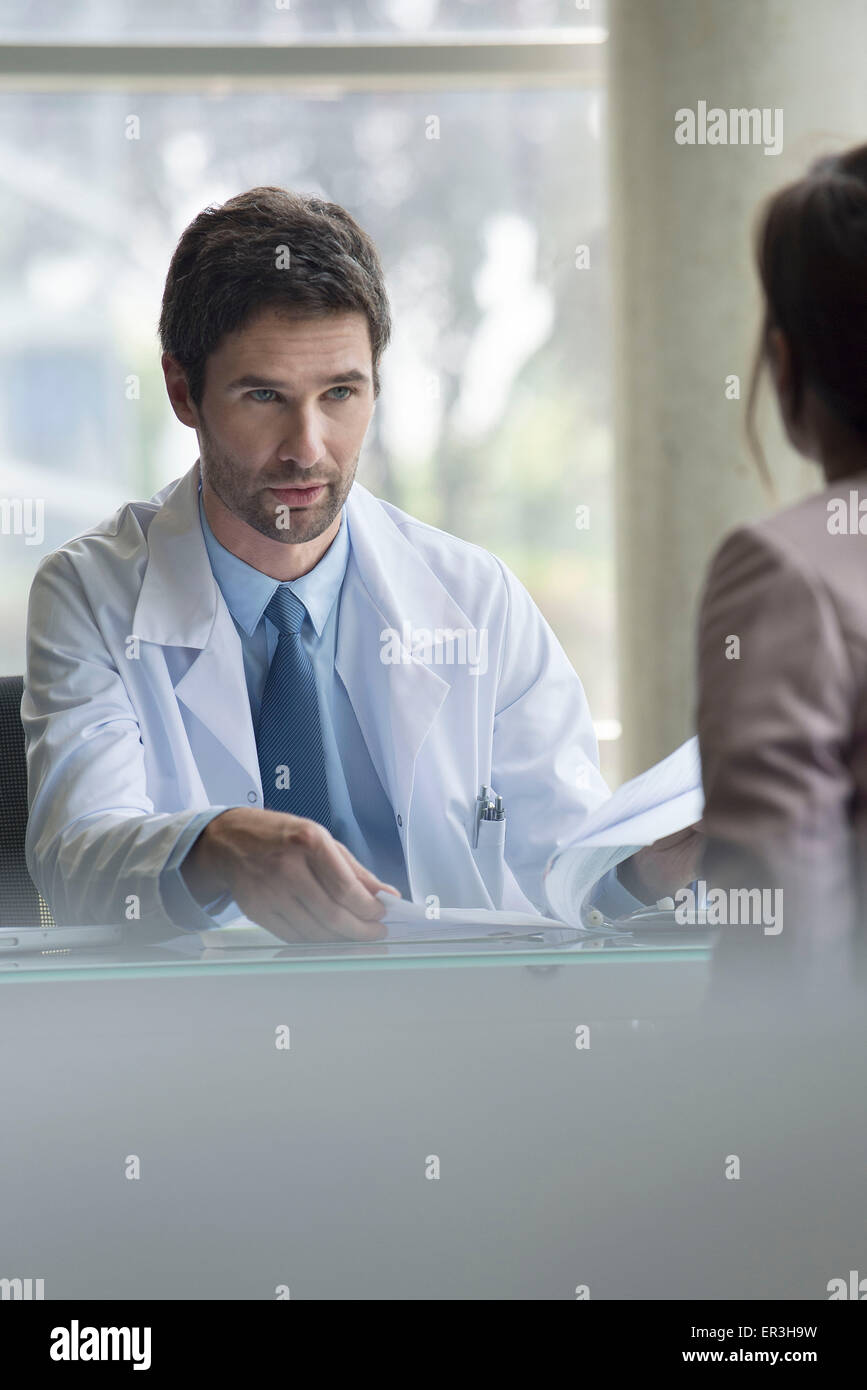 Doctor explaining concerning results to patient Stock Photo - Alamy