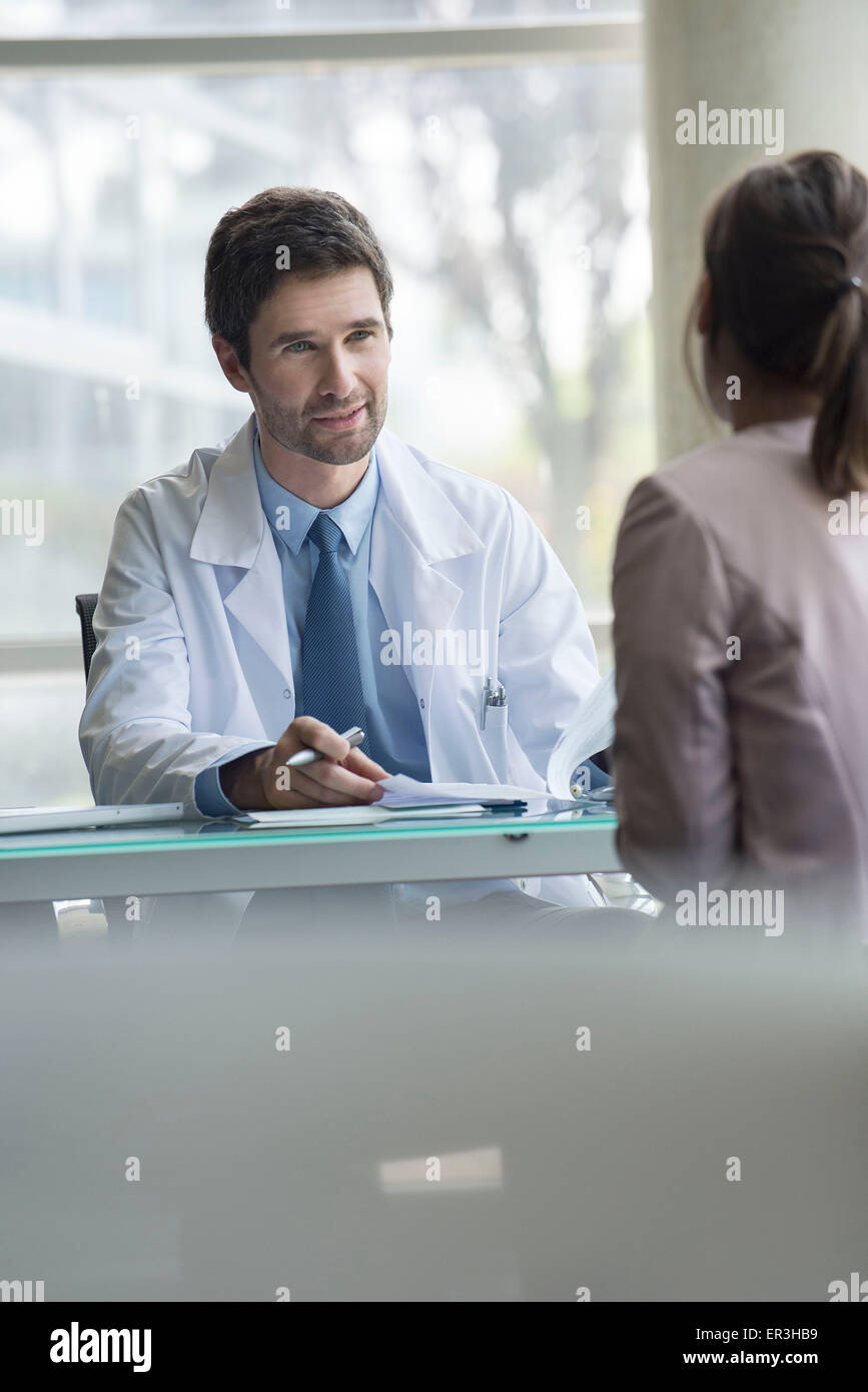 Patient listening as doctor explains test results Stock Photo - Alamy