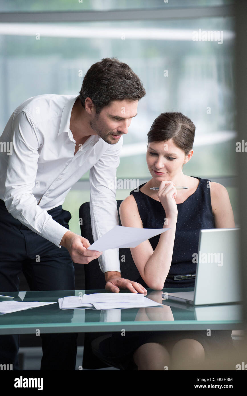 Colleagues working together in office Stock Photo - Alamy