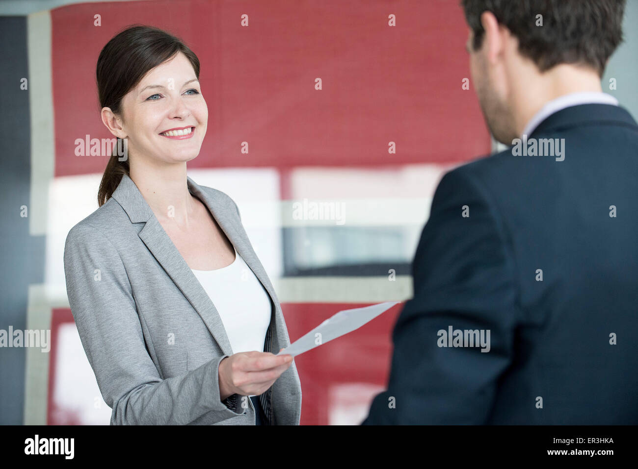 Hotel reception staff delivering fax to guest Stock Photo - Alamy