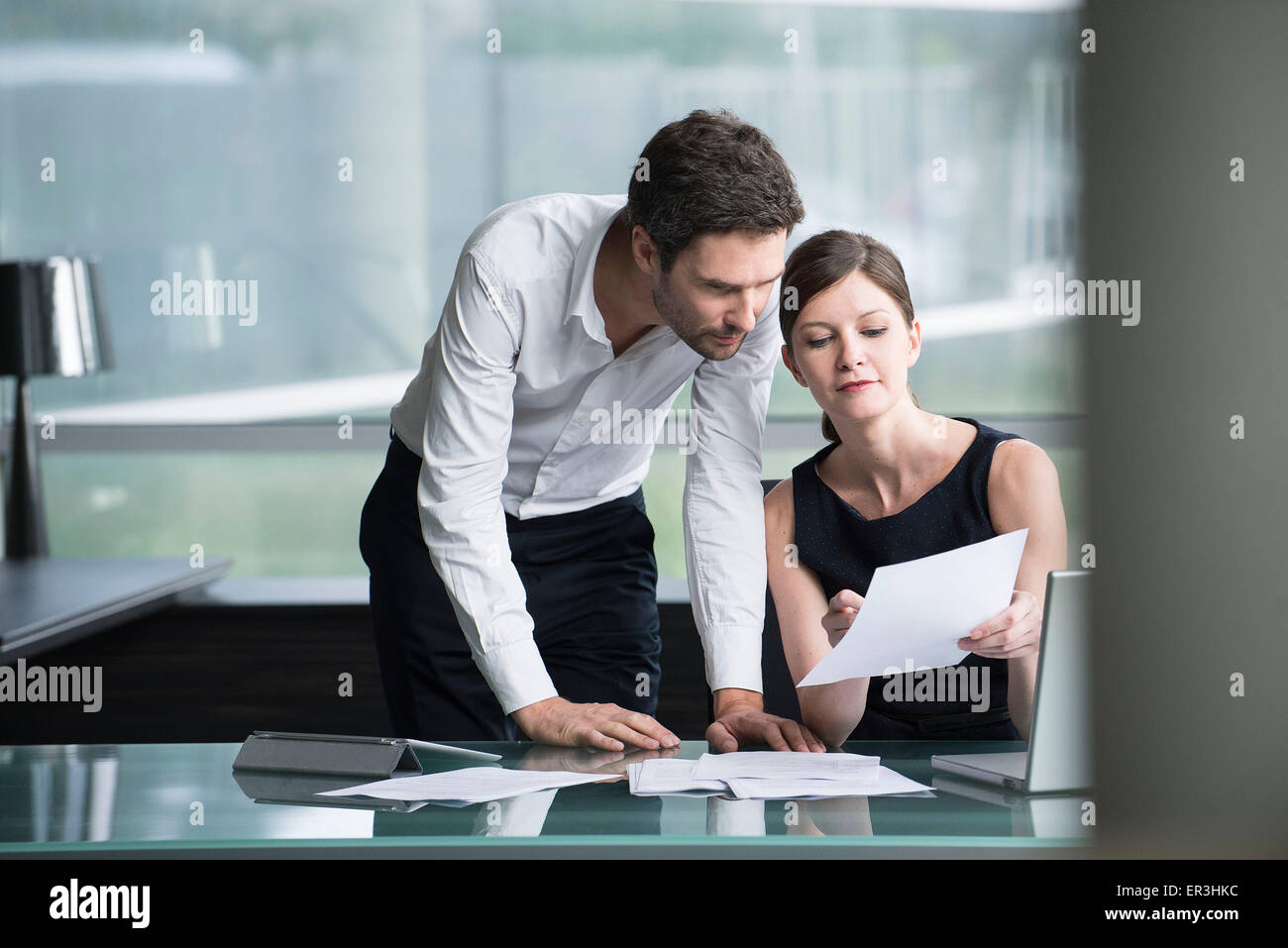 Woman leaning toward coworker hi-res stock photography and images - Alamy