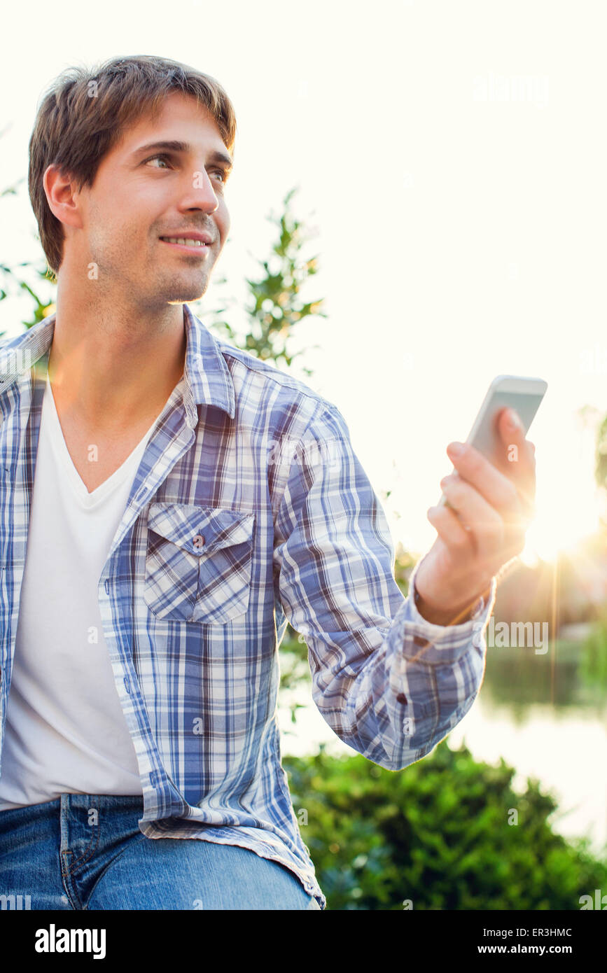 Man sending inspired tweet while enjoying being outdoors Stock Photo ...