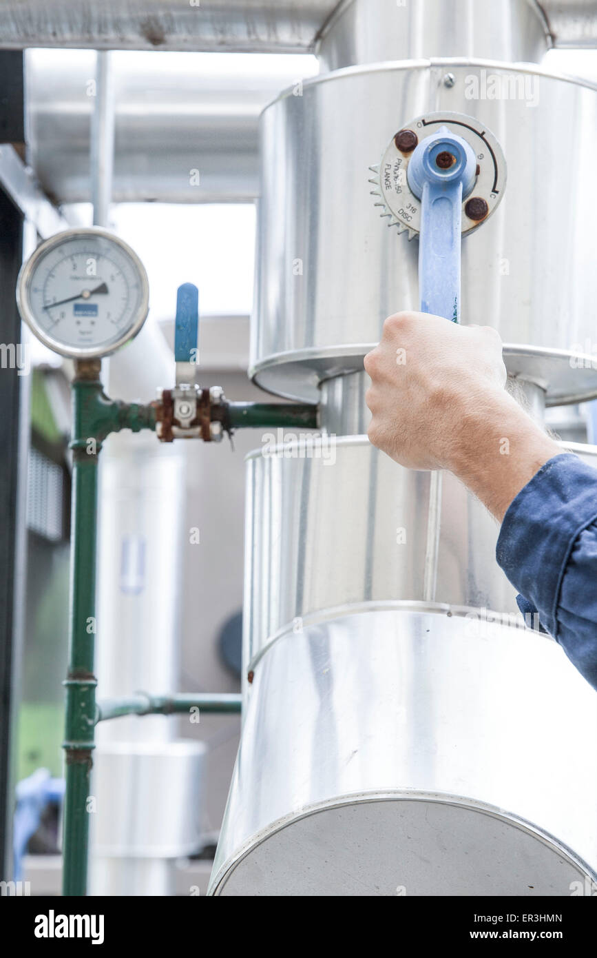 Worker adjusting control lever on industrial equipment Stock Photo - Alamy