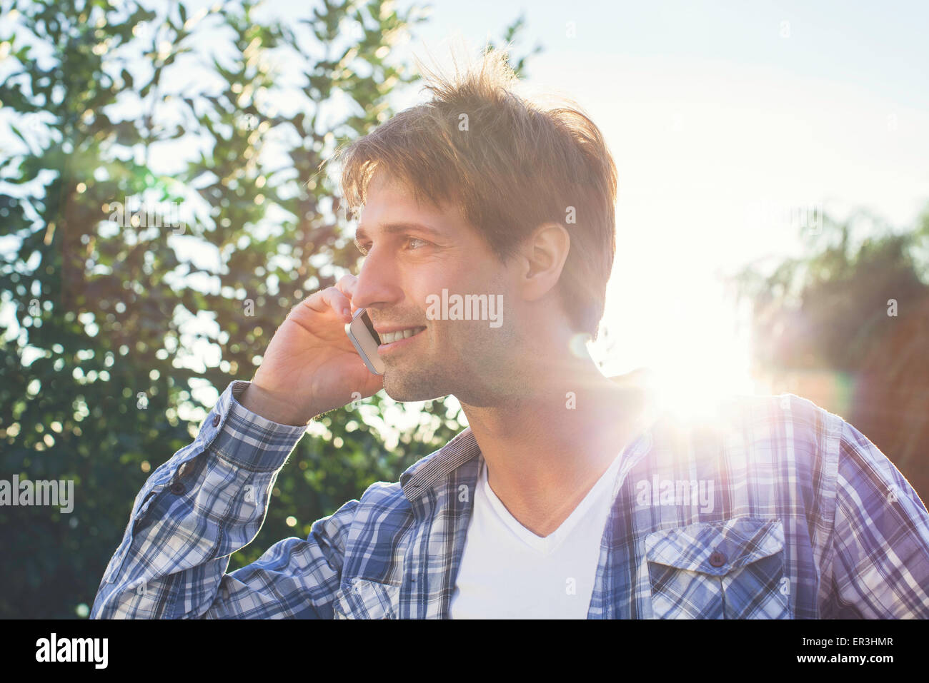 Man taking phone call on cell phone while enjoying being outdoors Stock ...