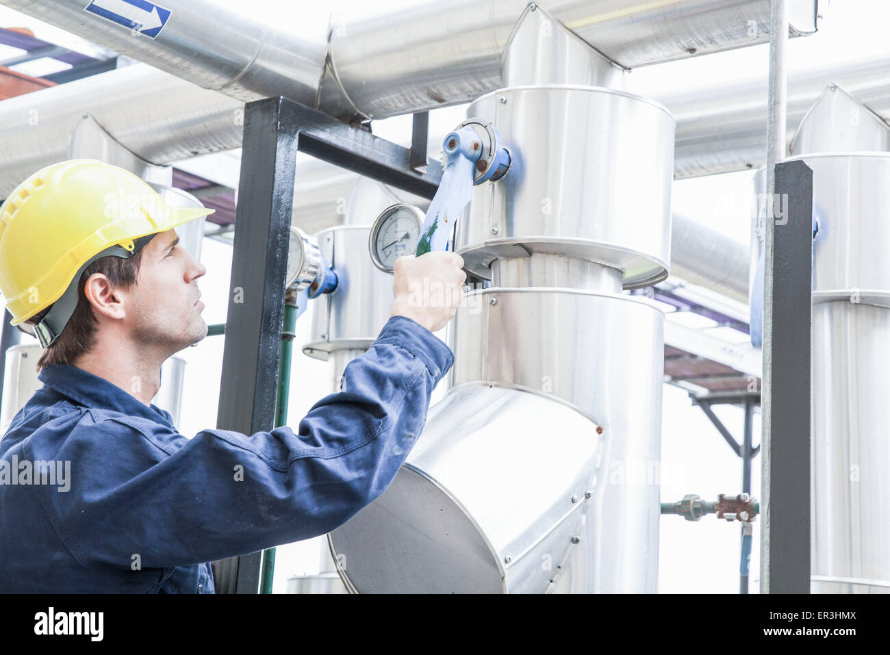 Skilled worker working on industrial equipment Stock Photo - Alamy