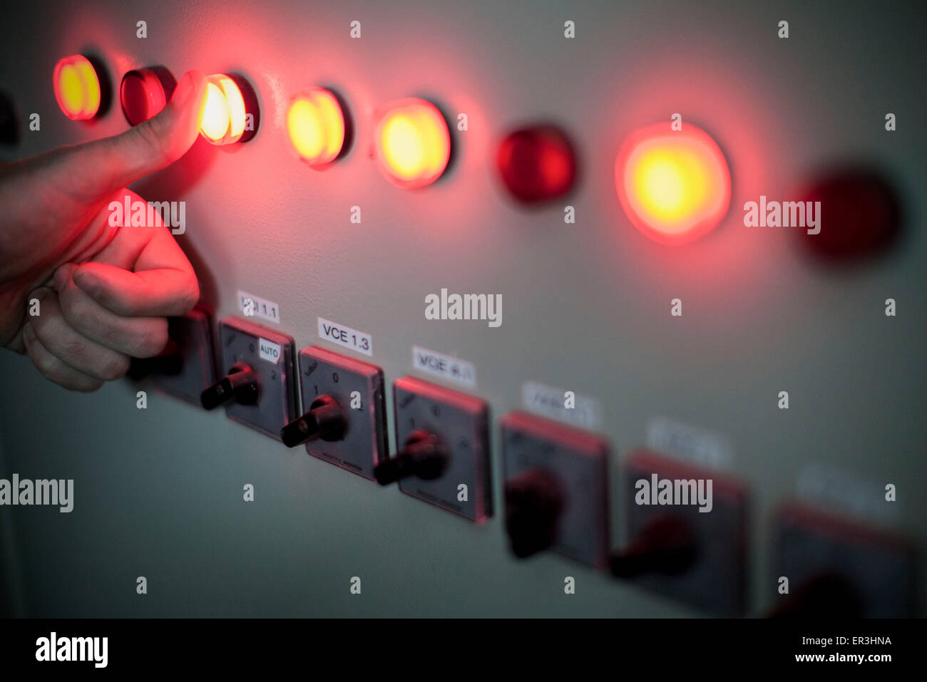 Worker pressing illuminated buttons on industrial control panel Stock ...