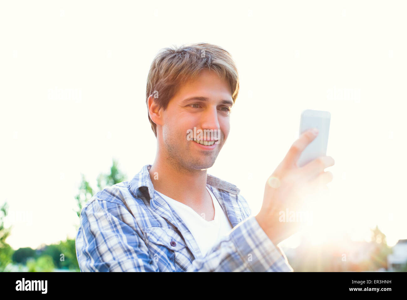 Man text messaging while enjoying outdoors Stock Photo - Alamy